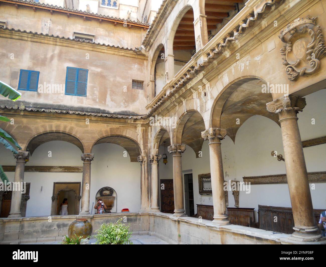 A beautifully designed courtyard showcases classic arches and lush ...