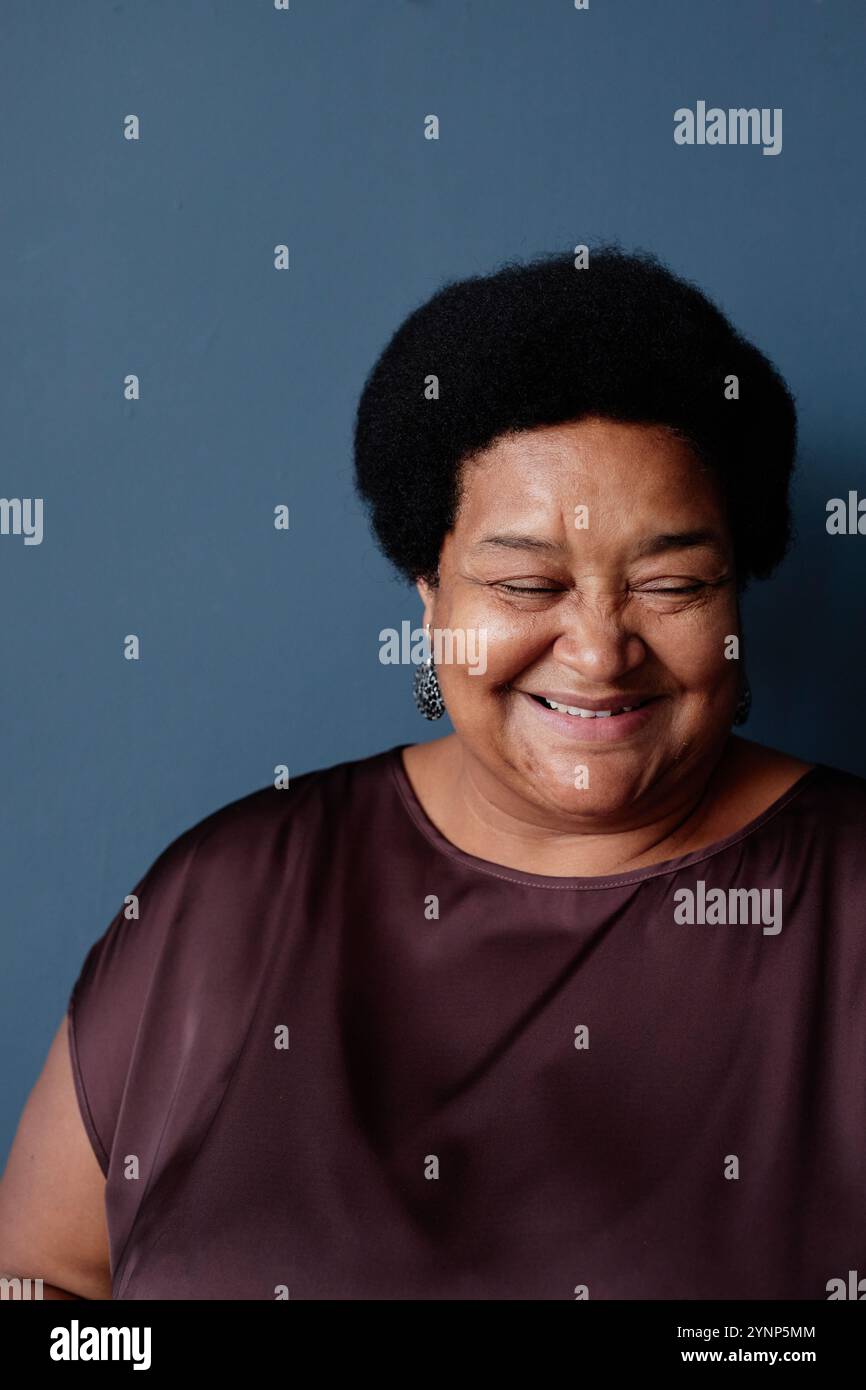 Minimal candid portrait of African American senior woman smiling with ...