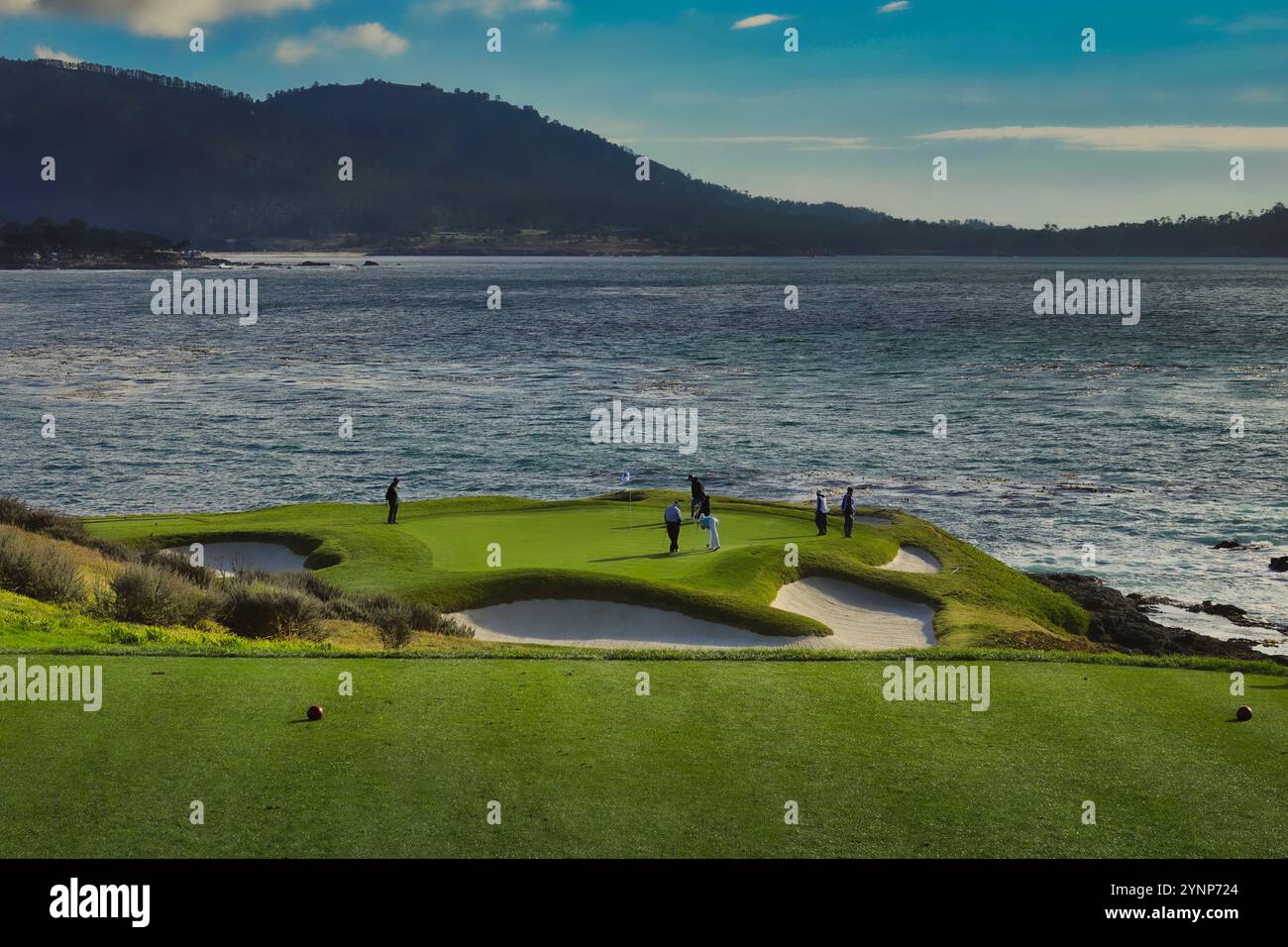 Pebble Beach, Monterey Peninsula, California USA - 2024 Golfers play the famous short par three ...