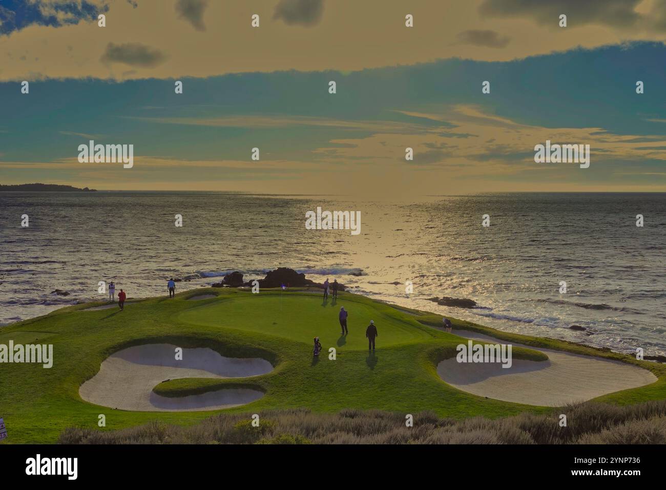 Pebble Beach, Monterey Peninsula, California USA - 2024 Golfers play the famous short par three ...