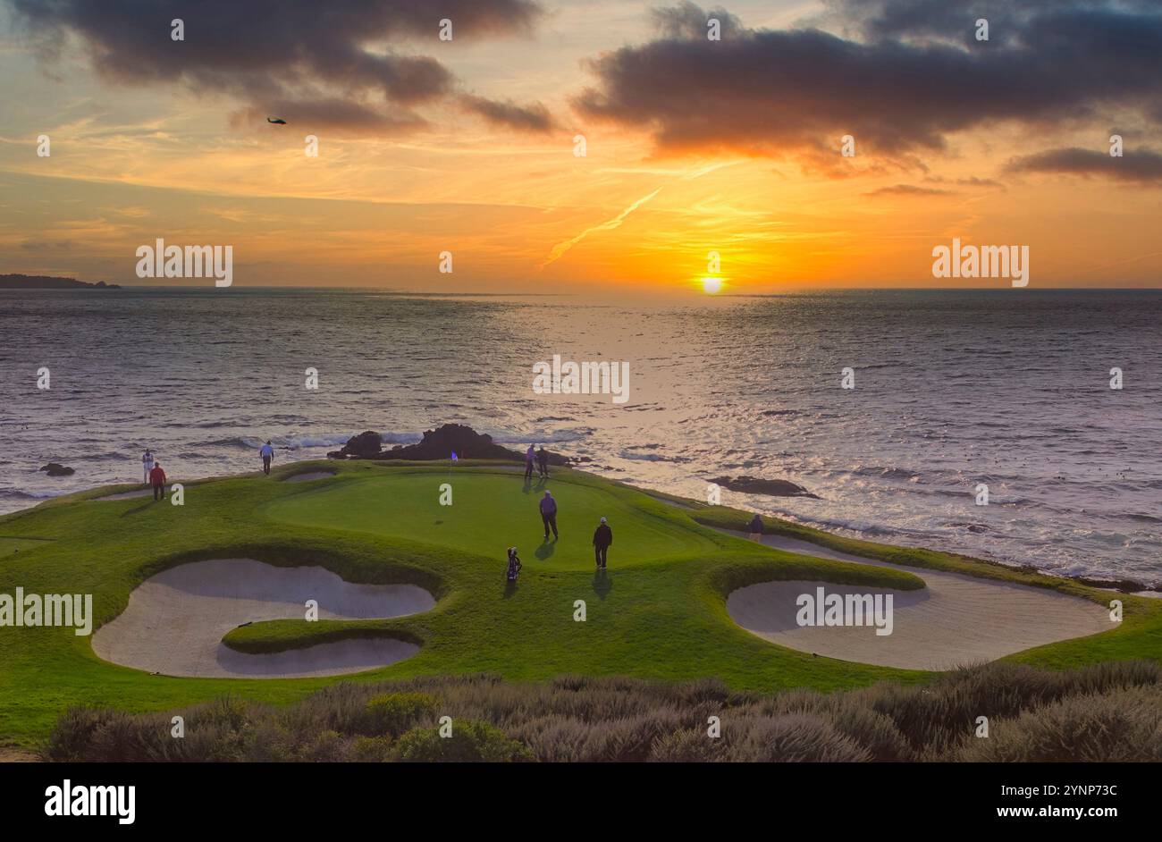 Pebble Beach, Monterey Peninsula, California USA - 2024 Golfers play the famous short par three ...