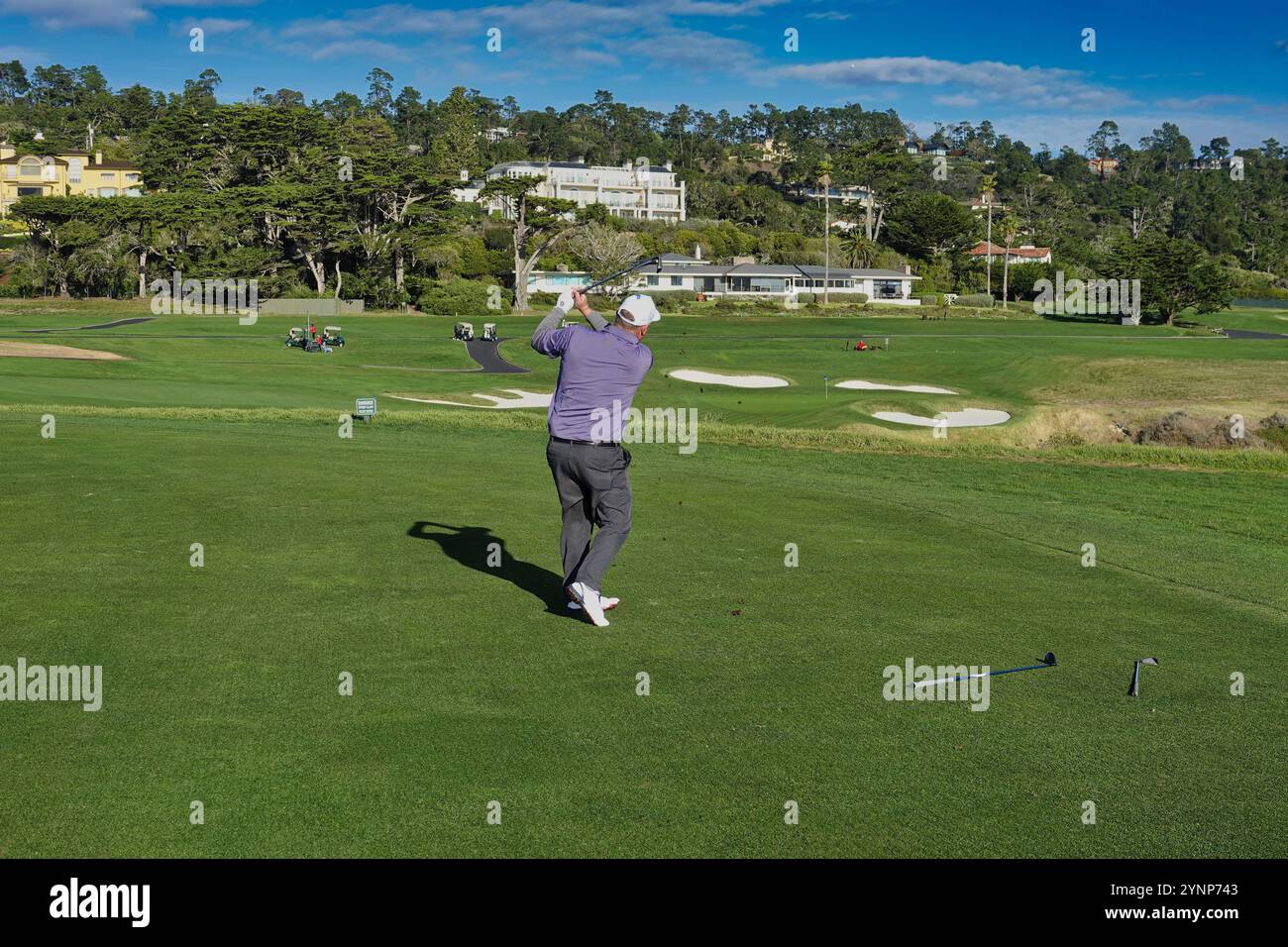 Pebble Beach, Monterey Peninsula, California USA - 2024 Male golfer plays second shot to the 8th ...