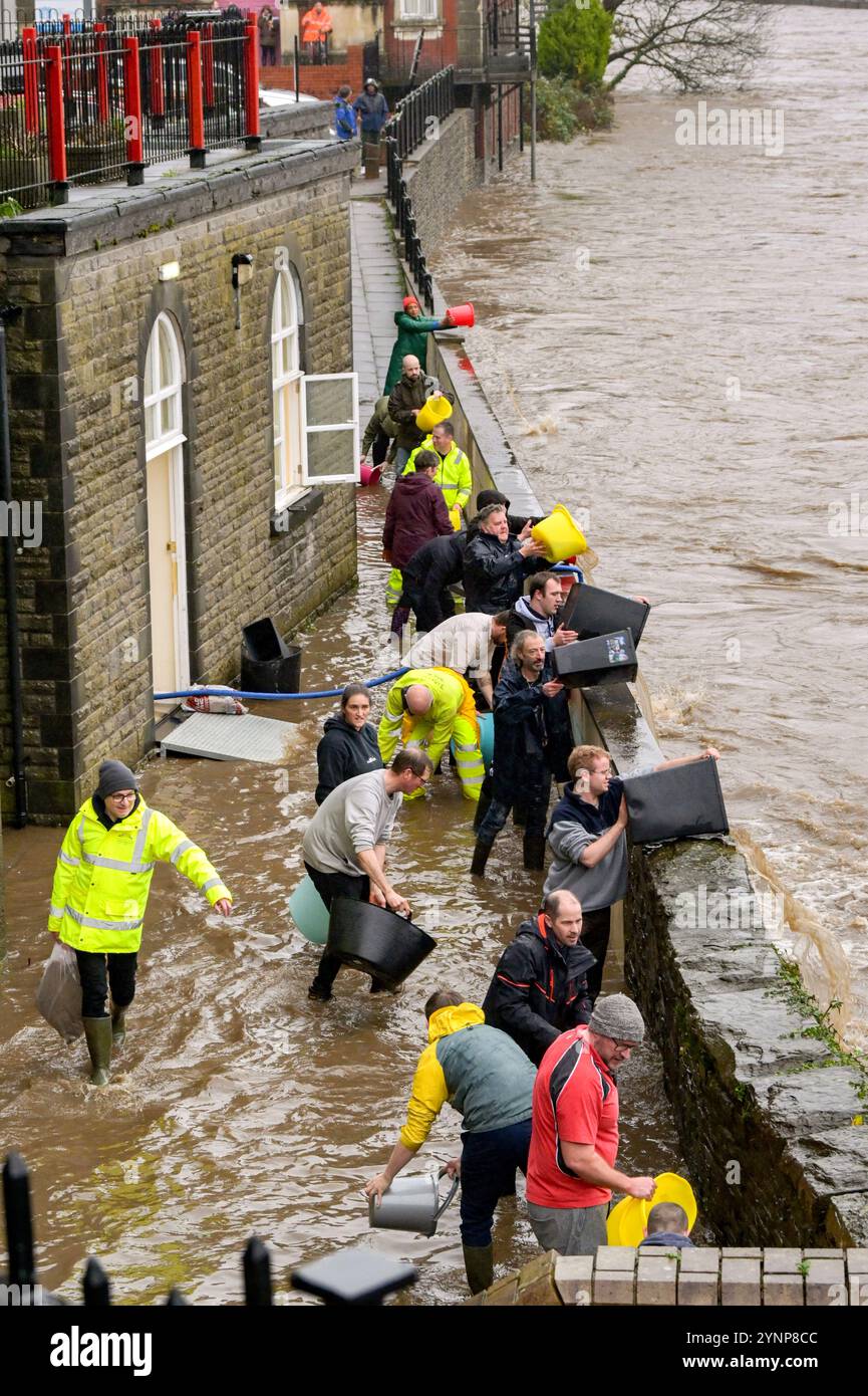 Pontypridd, Wales, UK - 24 November 2024: Volunteers using buckets and ...