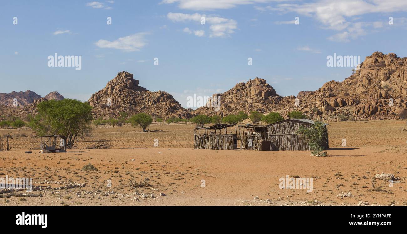 A dry desert landscape with rocks and a hut under a blue sky, Erongo ...