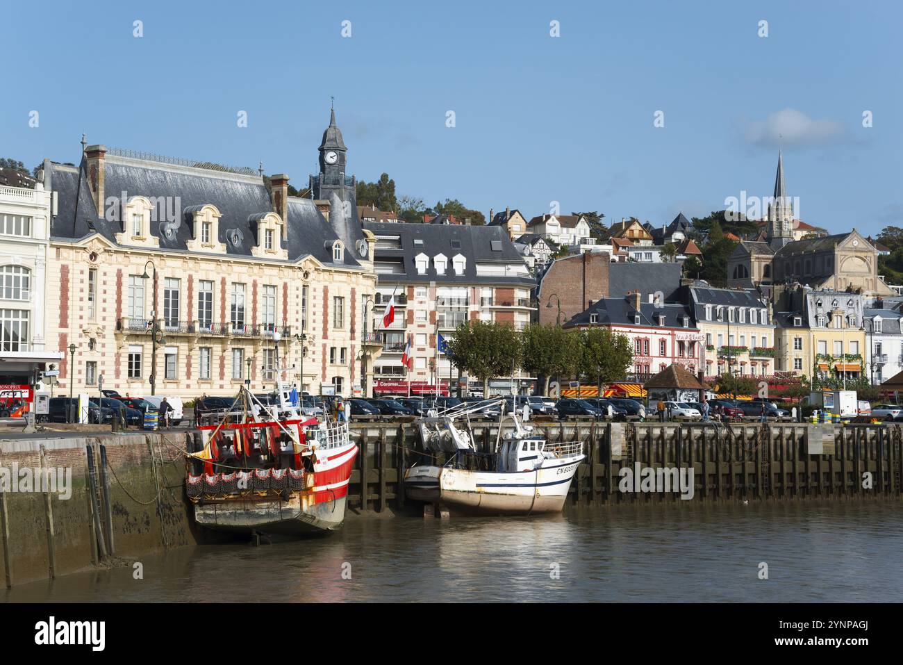 Historic harbour with fishing boats and church towers under a sunny sky, Trouville-sur-Mer ...