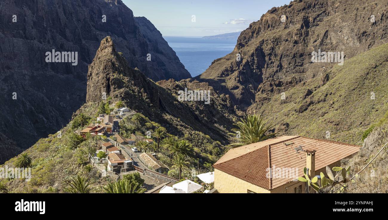 The mountain village of Masca surrounded by volcanic rock formations ...