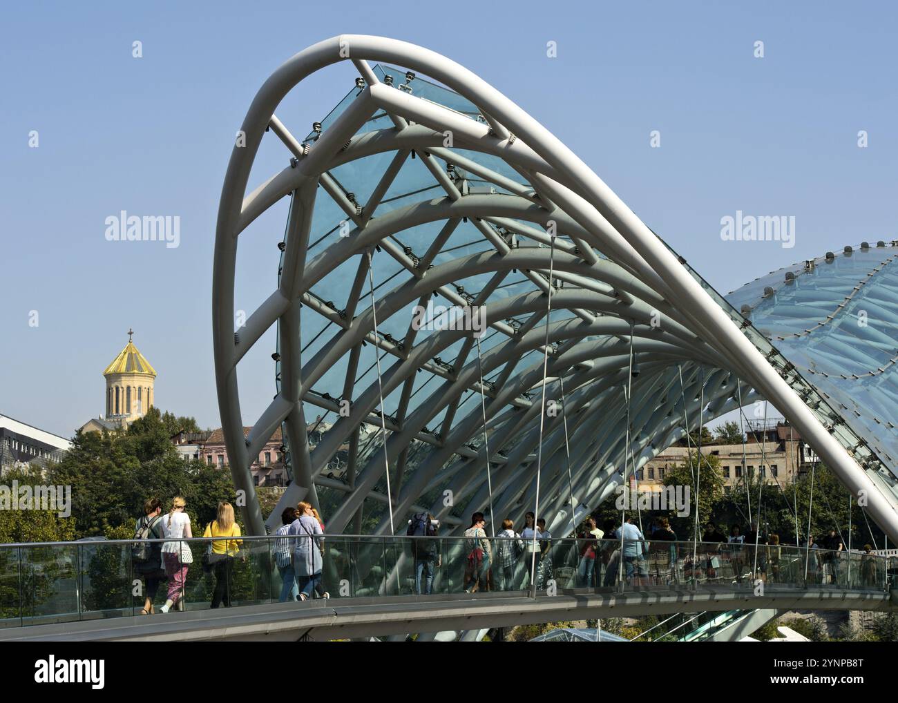 The arched futuristic Peace Bridge over the River Kura, architect ...