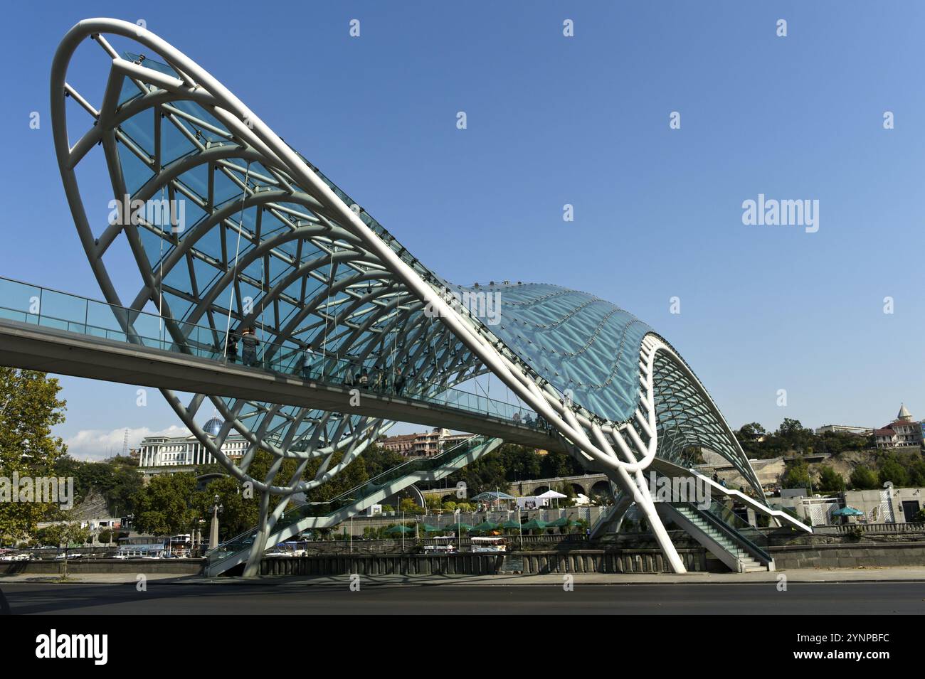 The arched futuristic peace bridge over the river kura hi-res stock ...