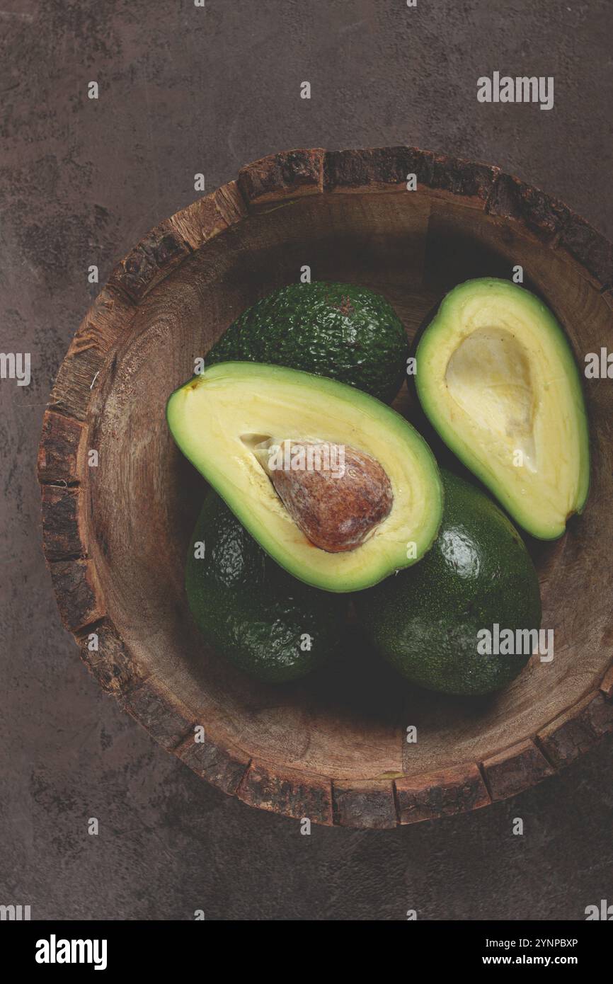 Fresh, sliced avocado, in a wooden plate, top view, food background ...