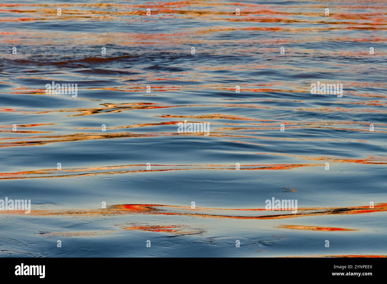 Reflections on water surface, waves with colourful, smooth patterns ...