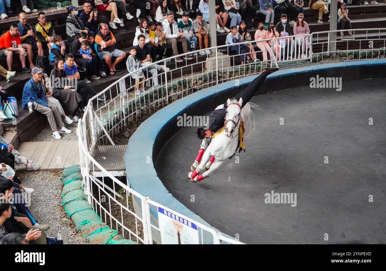 A performer shows a trick during a horse show in Cingjing, Ren'ai of ...