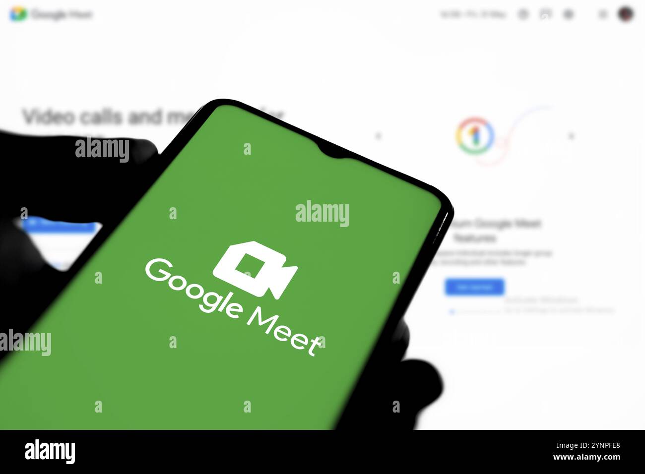 Google Meet app on smartphone screen. On a blue background, Google Meet ...