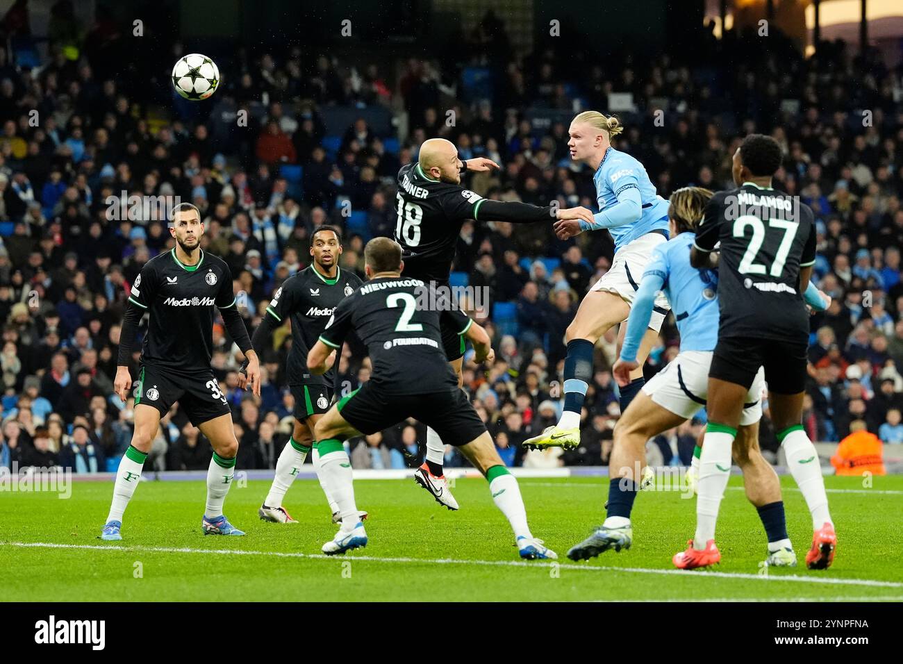 Manchester City's Erling Haaland (third right) attempts a header on ...