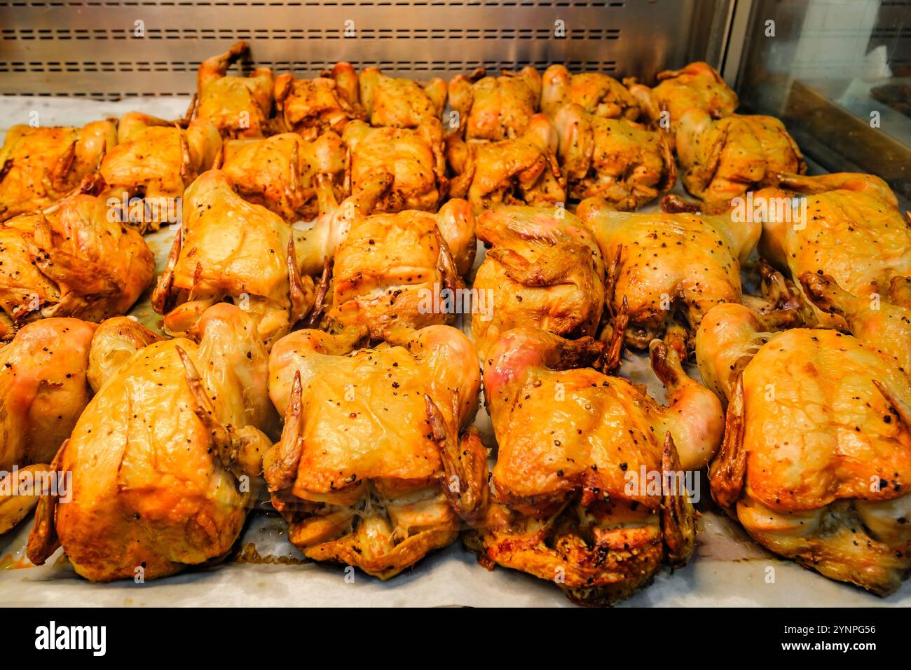 whole cooked grilled fried chickens on counter at supermarket Stock ...