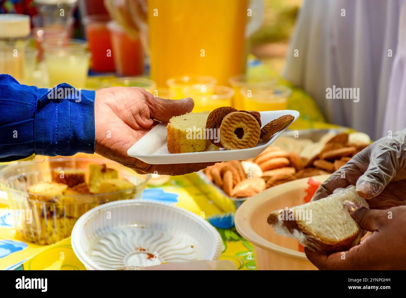 Person receiving various foods in a tray at a community breakfast Stock ...