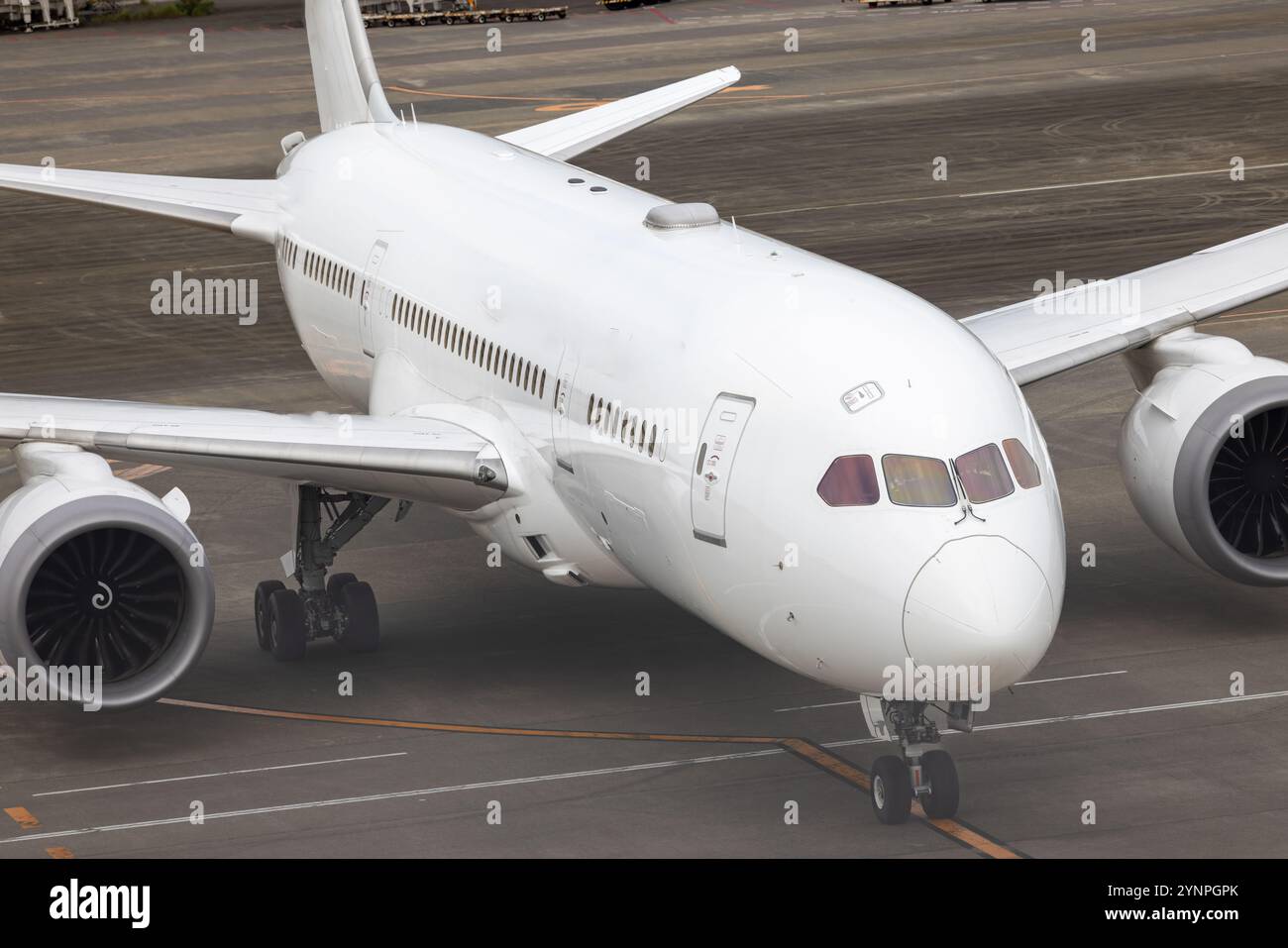 Side-front view of a modern passenger airplane on the airport tarmac ...