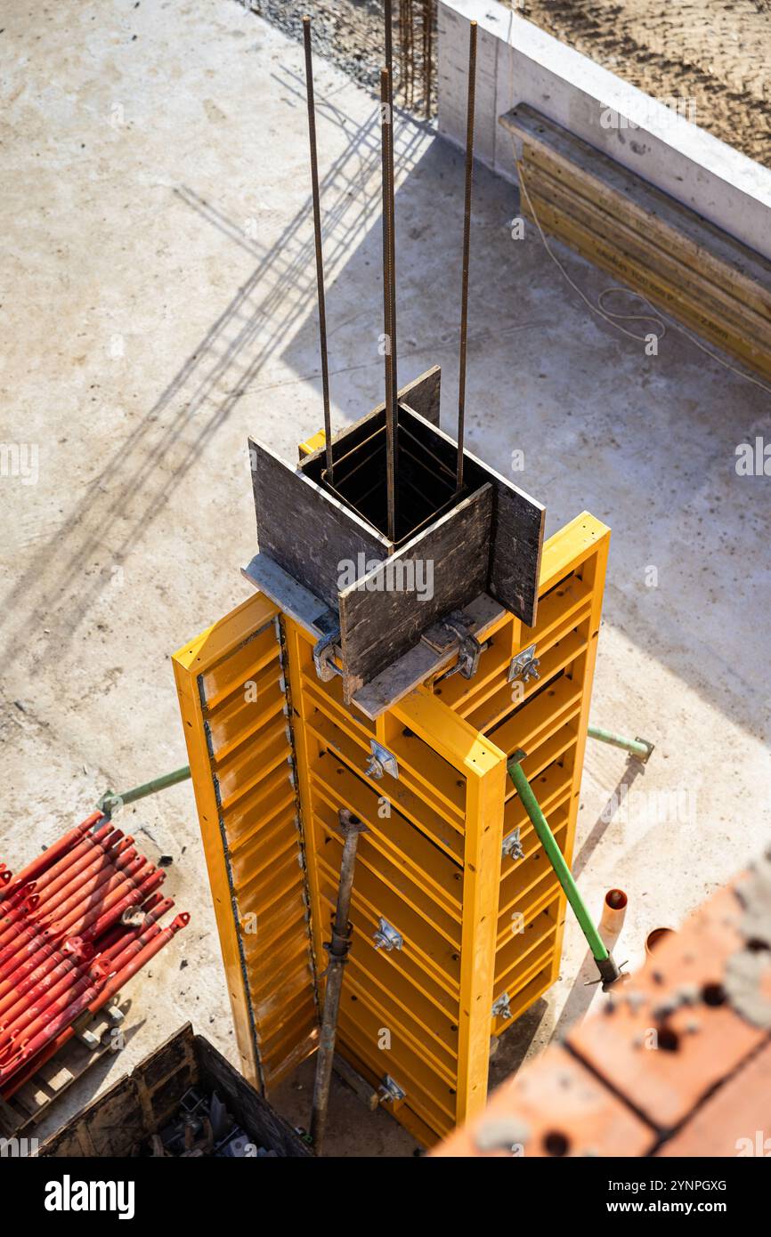 Vertical concrete formwork on construction site with reinforcement rods ...