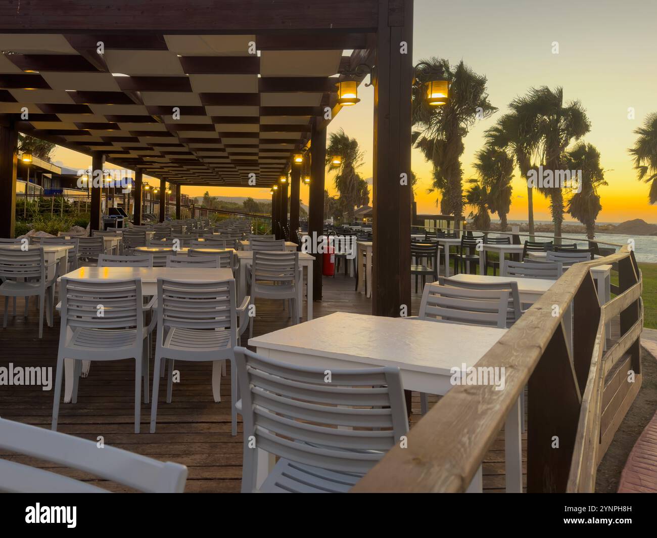 Sunset Dining Experience at a Beachfront Restaurant With Empty Tables ...
