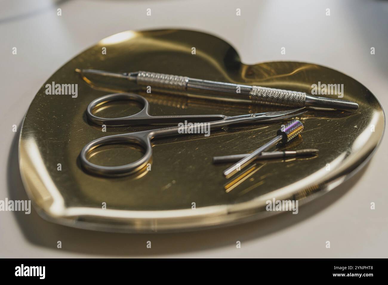 Tools for making nails in beauty parlor, scissors, cutter on a gold ...