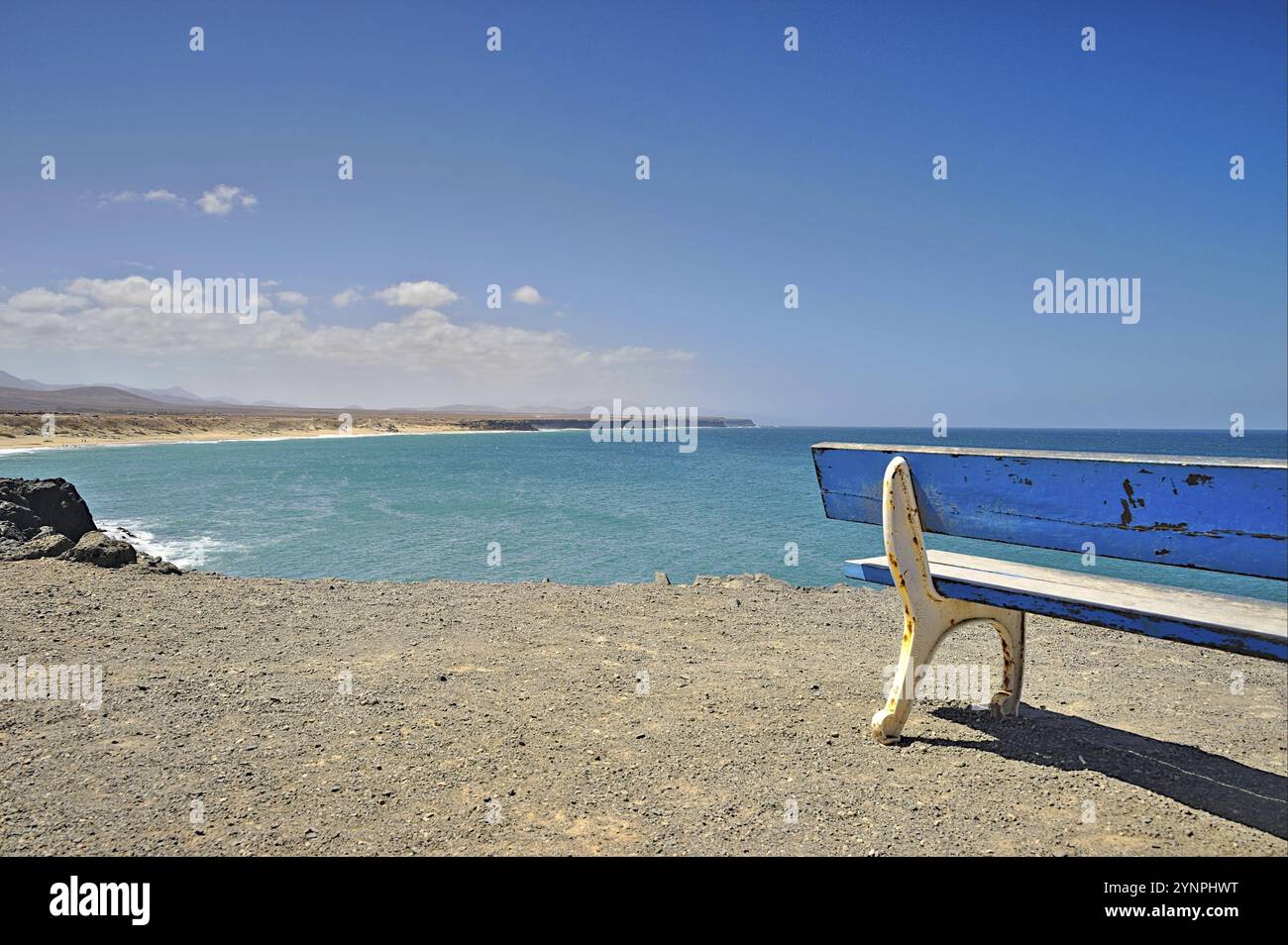 Blue bench near the Castillo del Toston. In the background a sandy ...