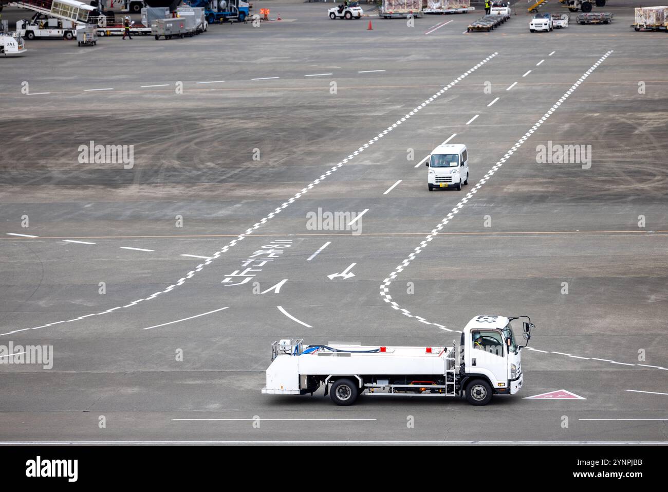 Airport ground vehicles on the tarmac with directional markings Stock ...