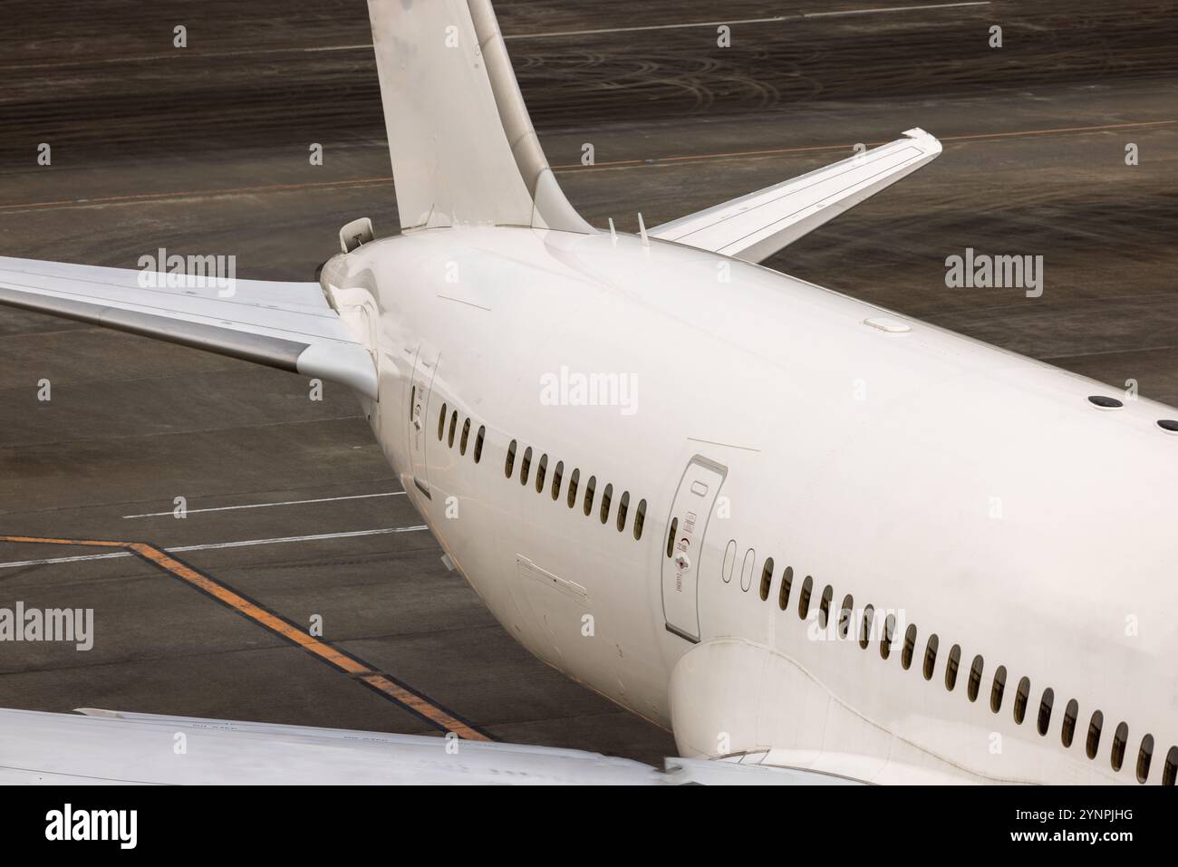 Close-up of an airplane tail section and wings on the tarmac Stock ...