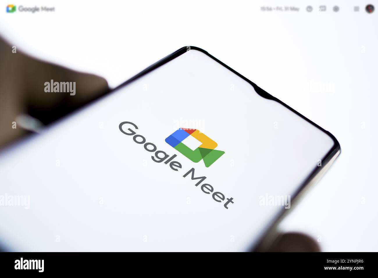 Google Meet app on smartphone screen. On a blue background, Google Meet ...