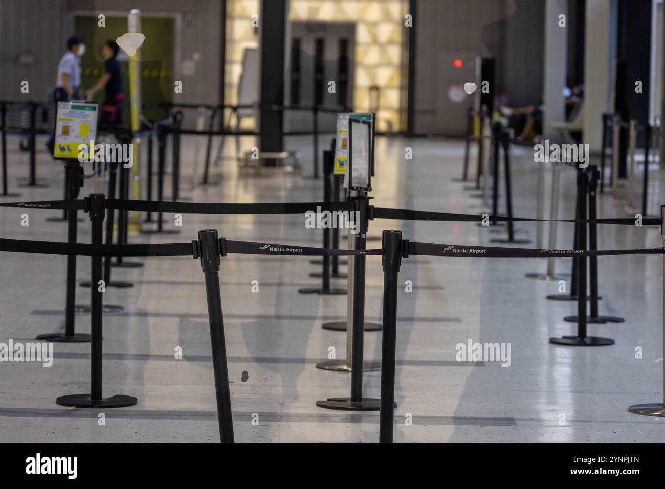 A deserted airport queue setup featuring black barriers with ...