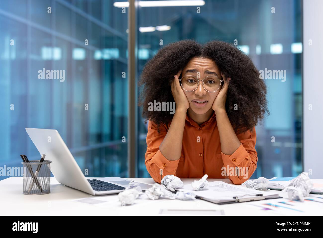 Stressed office worker overwhelmed by deadlines, surrounded by messy ...
