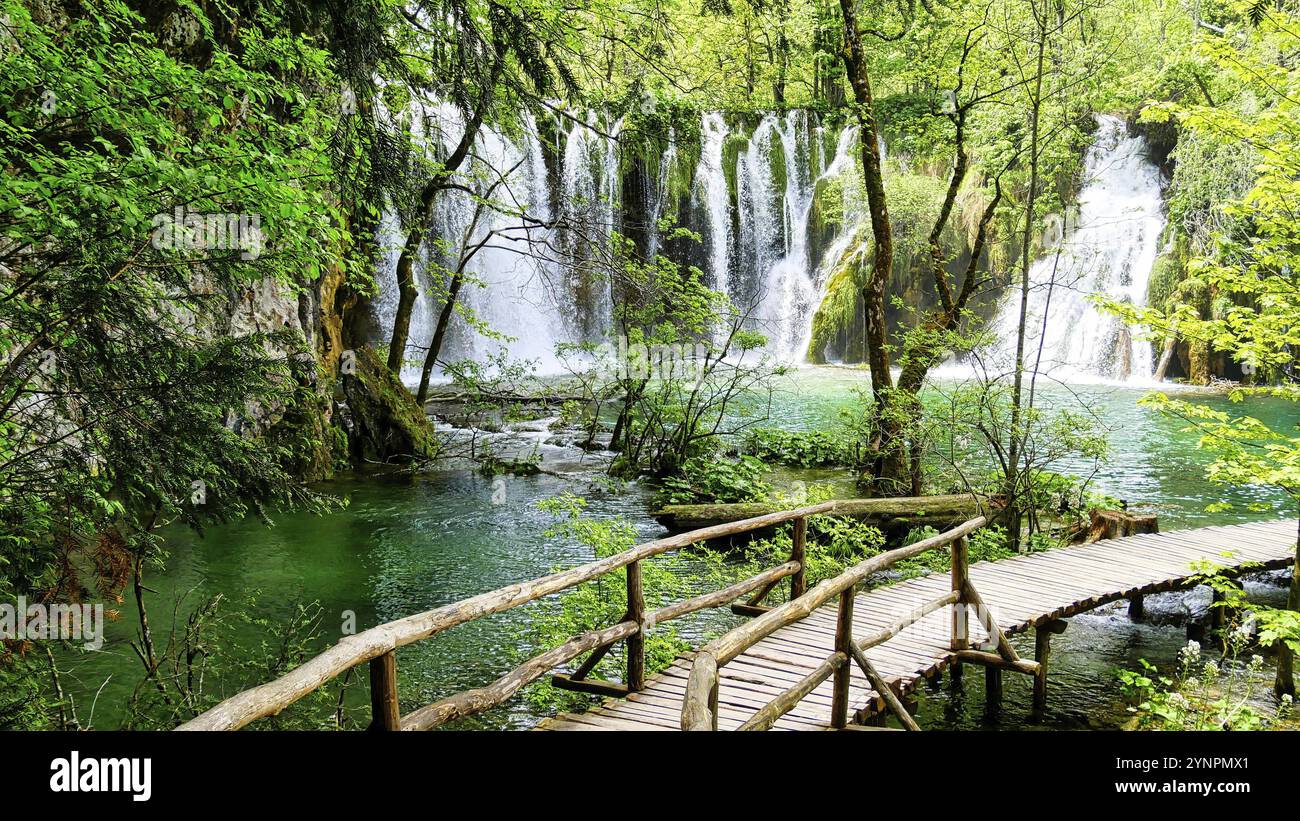 Circular boardwalk with bridge in front of waterfall in Plitvice Lakes ...