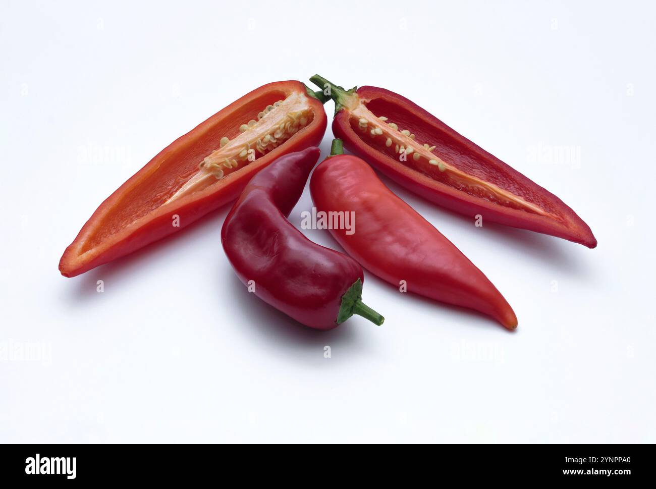 Whole and half images of various red and sweet peppers on white ...
