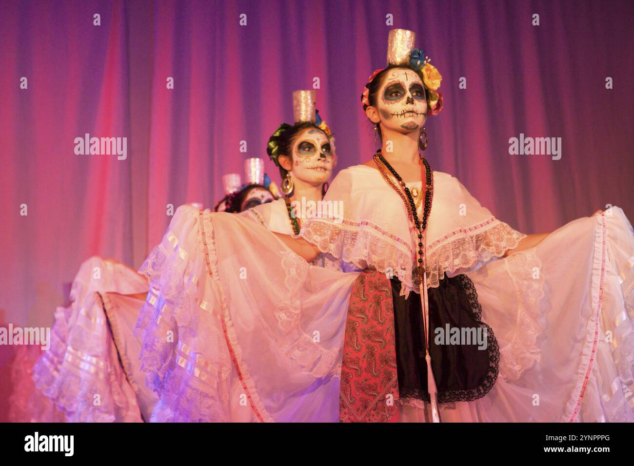 Young men and women in traditional dress dancing at party day of death ...