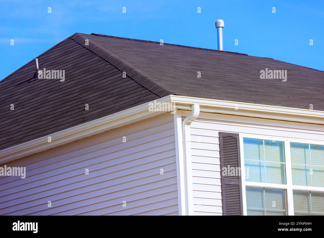 Well maintained residential roof featuring asphalt shingles, white ...