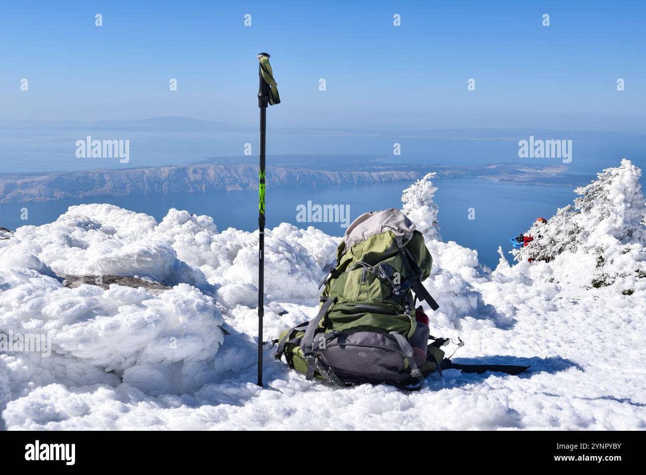 Hiking pole and backpack on mountain top Stock Photo - Alamy