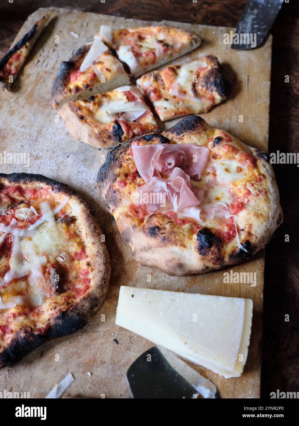 Sourdough pizza fresh from the oven, slightly burnt on one side and ...