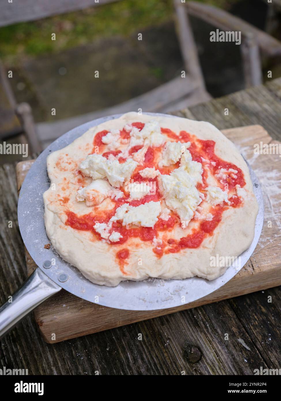 Sourdough pizza fresh from the oven, slightly burnt on one side and ...