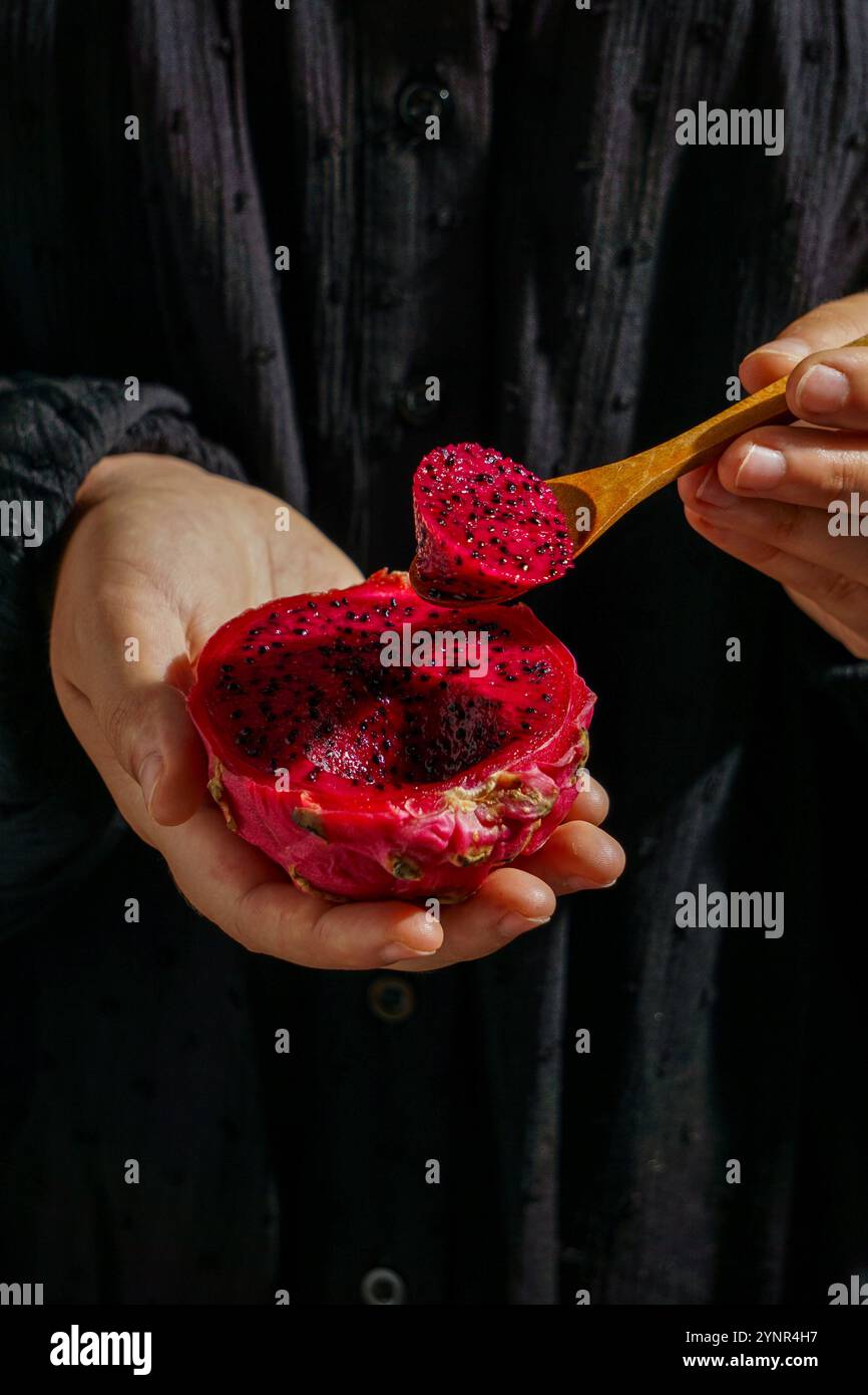 dragon fruit, also known as pitaya, cut open pink magenta-colored flesh ...