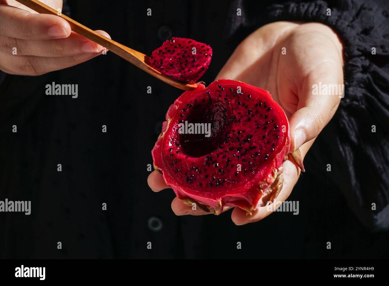 dragon fruit, also known as pitaya, cut open pink magenta-colored flesh ...