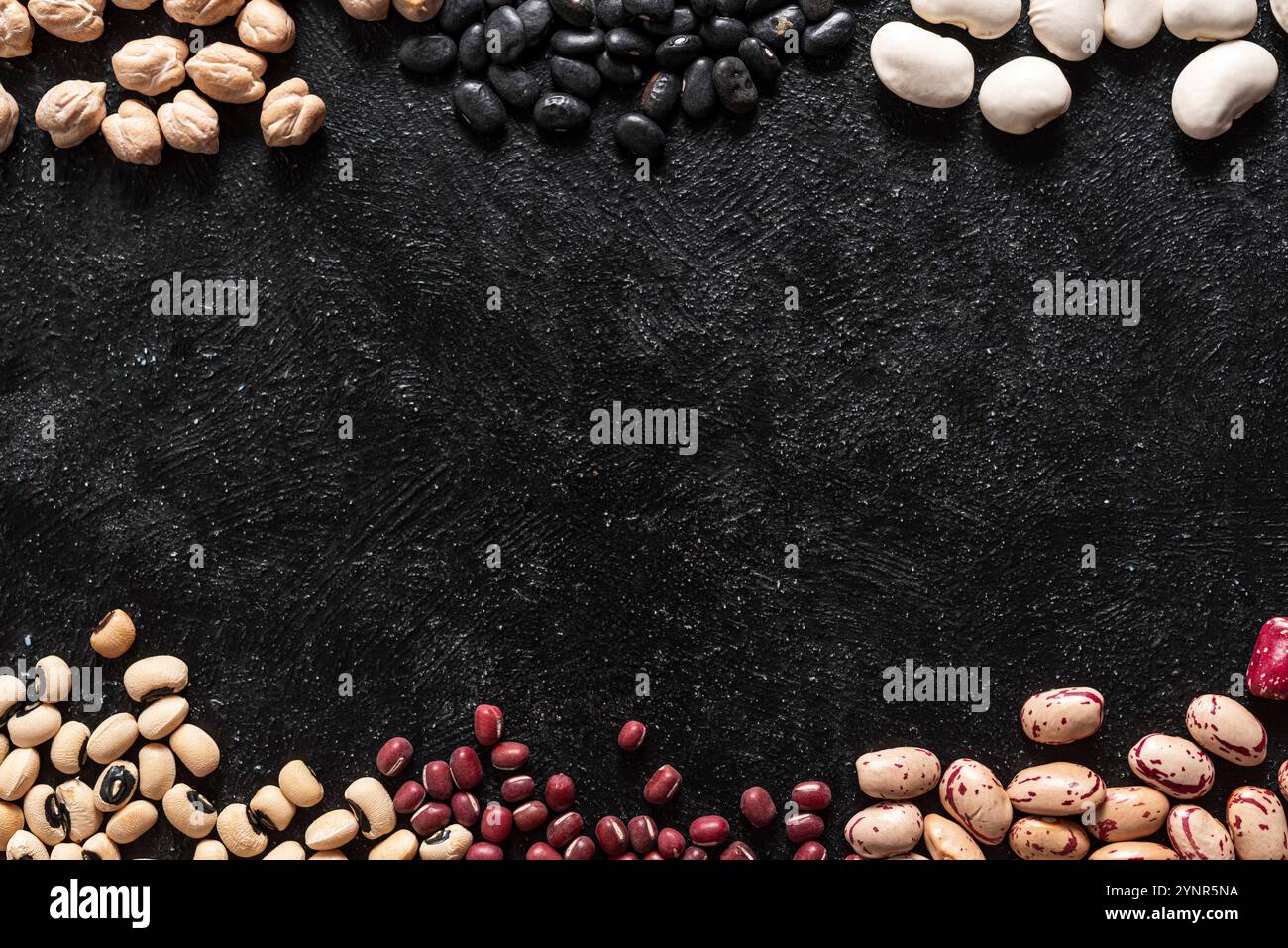 Beans on black backdrop for banner Stock Photo - Alamy