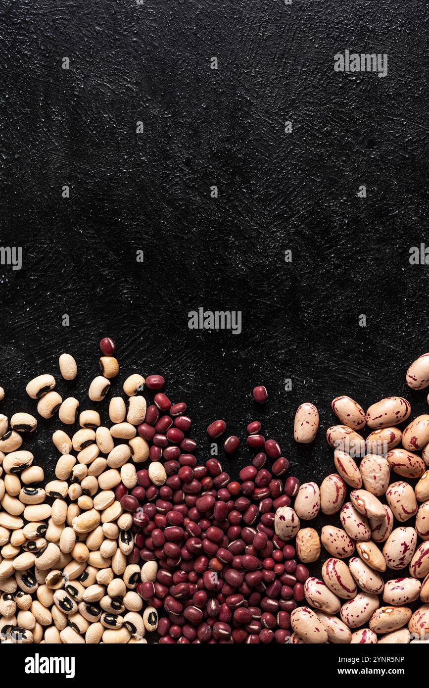 Beans on black backdrop for banner Stock Photo - Alamy