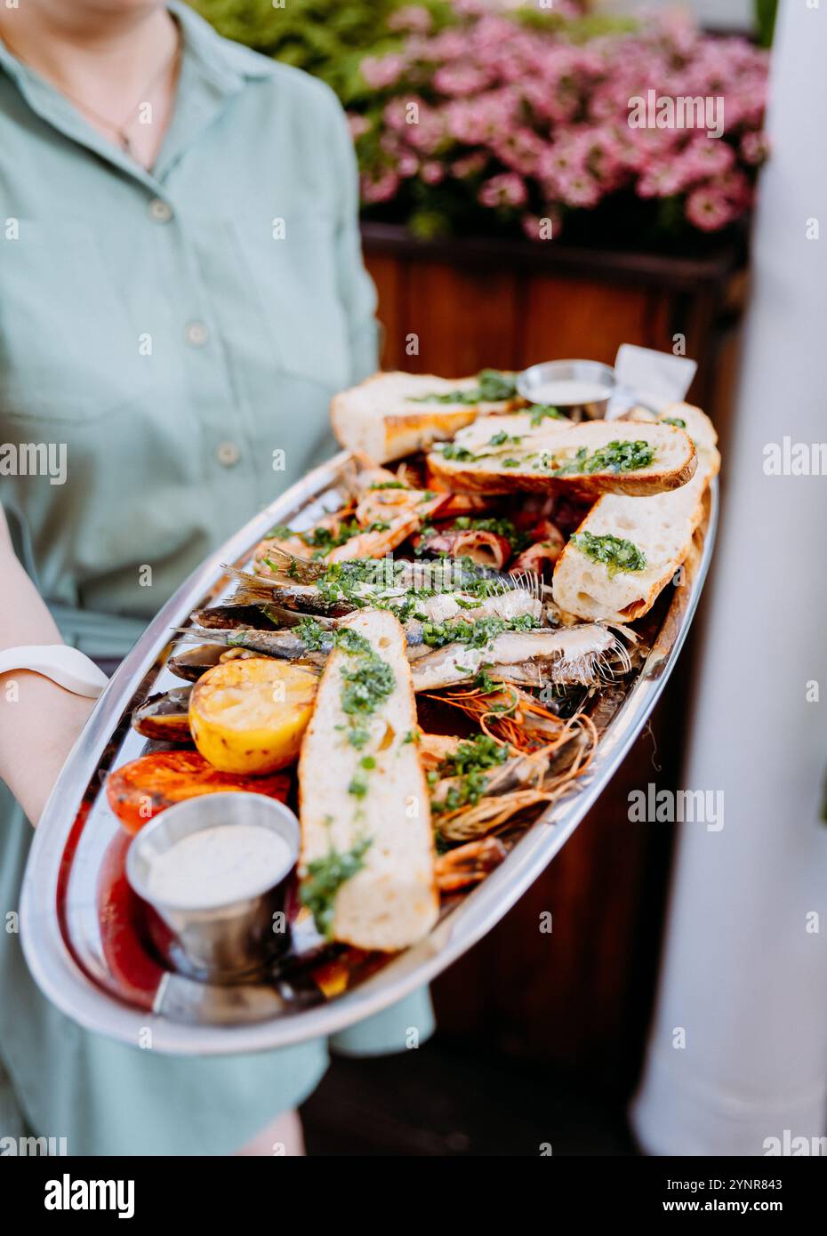 Seafood platter with grilled fish, shrimp, and herb bread served fresh ...