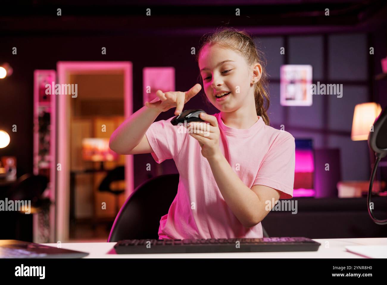 Child influencer filming wireless Bluetooth mouse review in studio ...