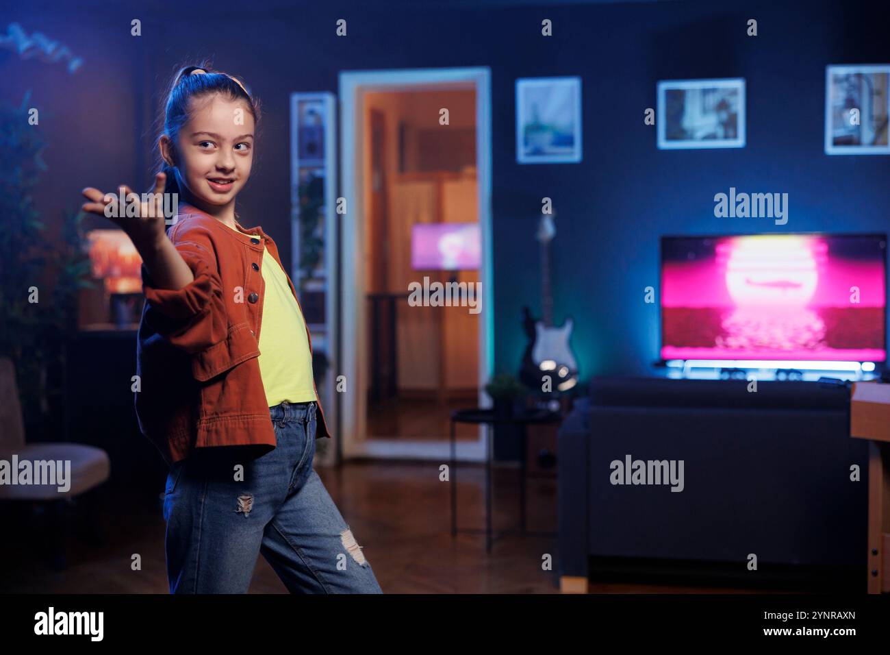 Upbeat kid records dance tutorial video in dimly lit studio for her ...