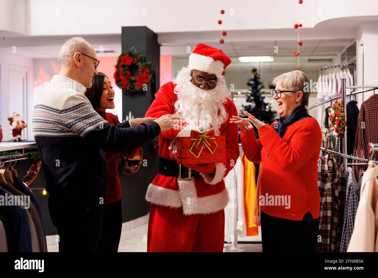 Santa drawing winners names in mall store, presenting lucky prize ...
