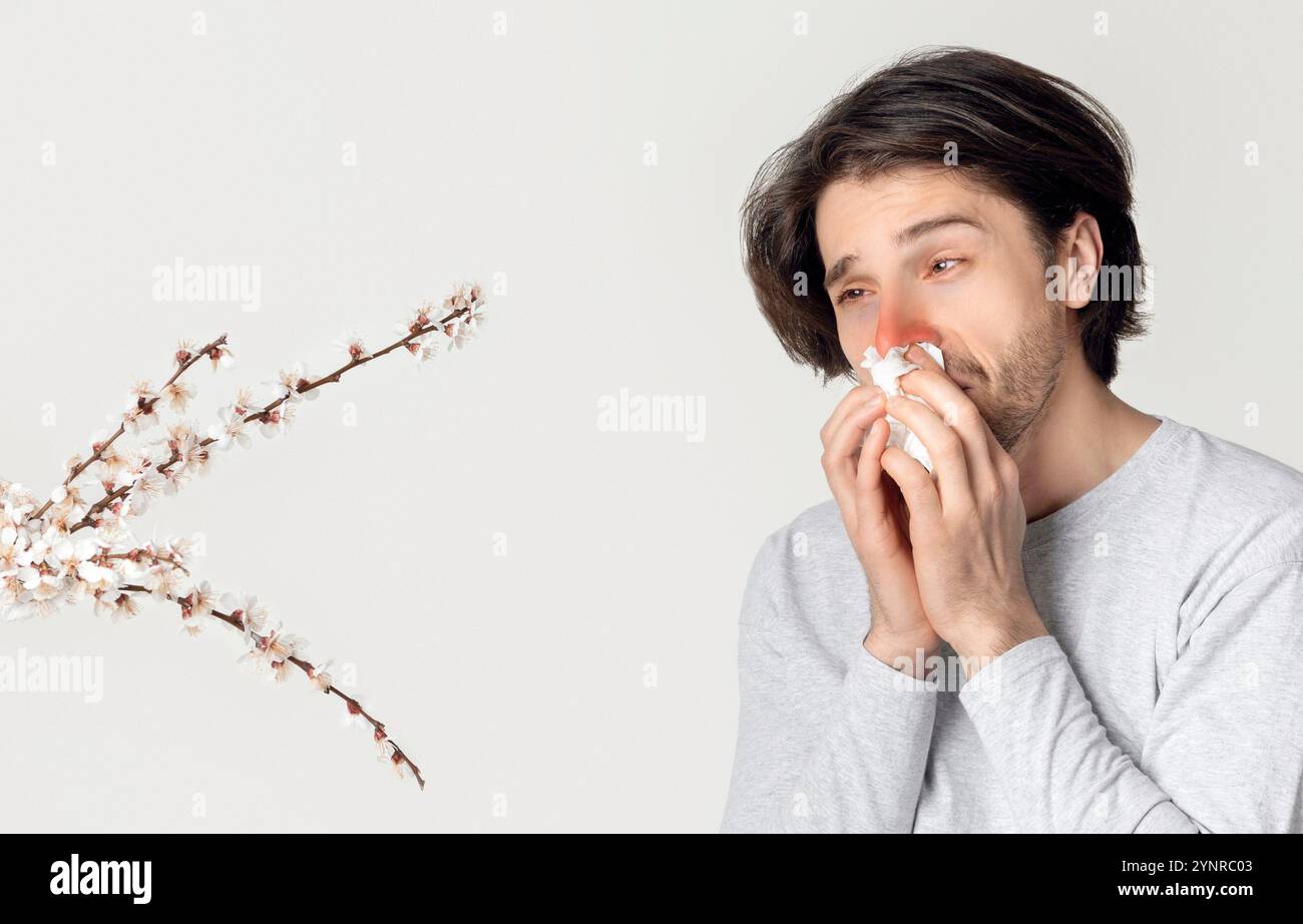 Man blowing nose. Pollen allergy symptoms, empty space Stock Photo - Alamy