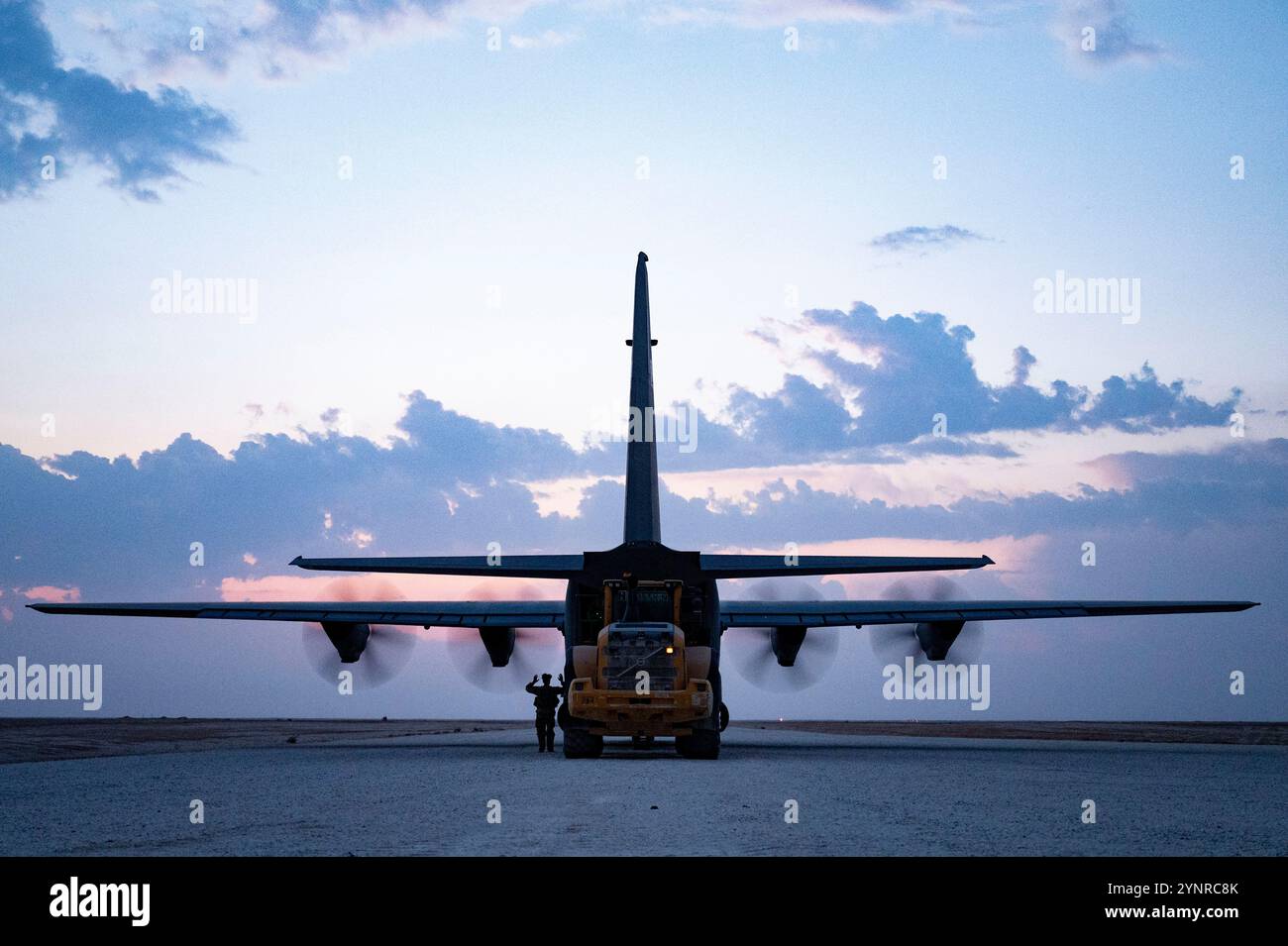A U.S. Air Force C-130J Super Hercules is loaded with cargo before a ...