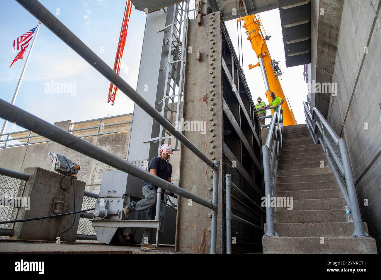 Contractors from Barnhart Crane and Rigging Co. use a mobile crane to ...