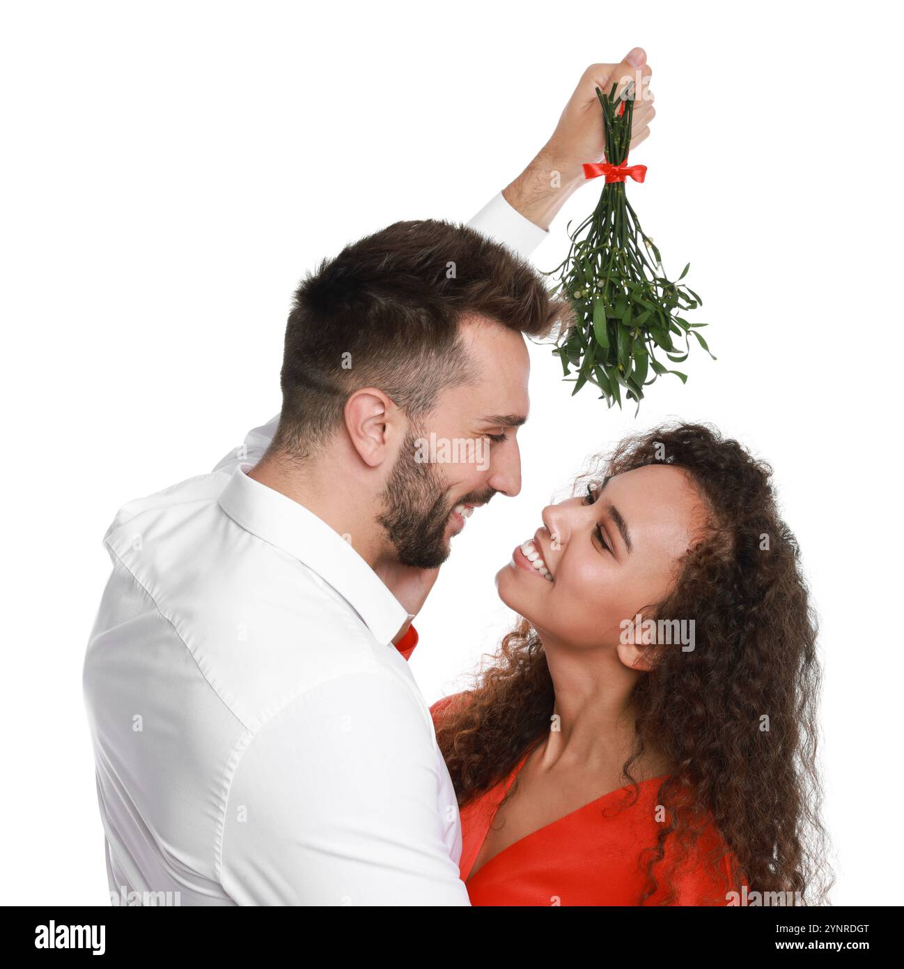 Lovely couple under mistletoe bunch on white background Stock Photo - Alamy