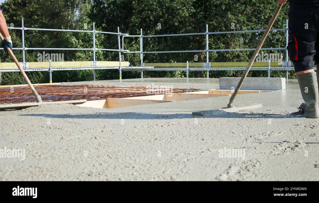 Workers filling the second floor ground with concrete, core and shell ...
