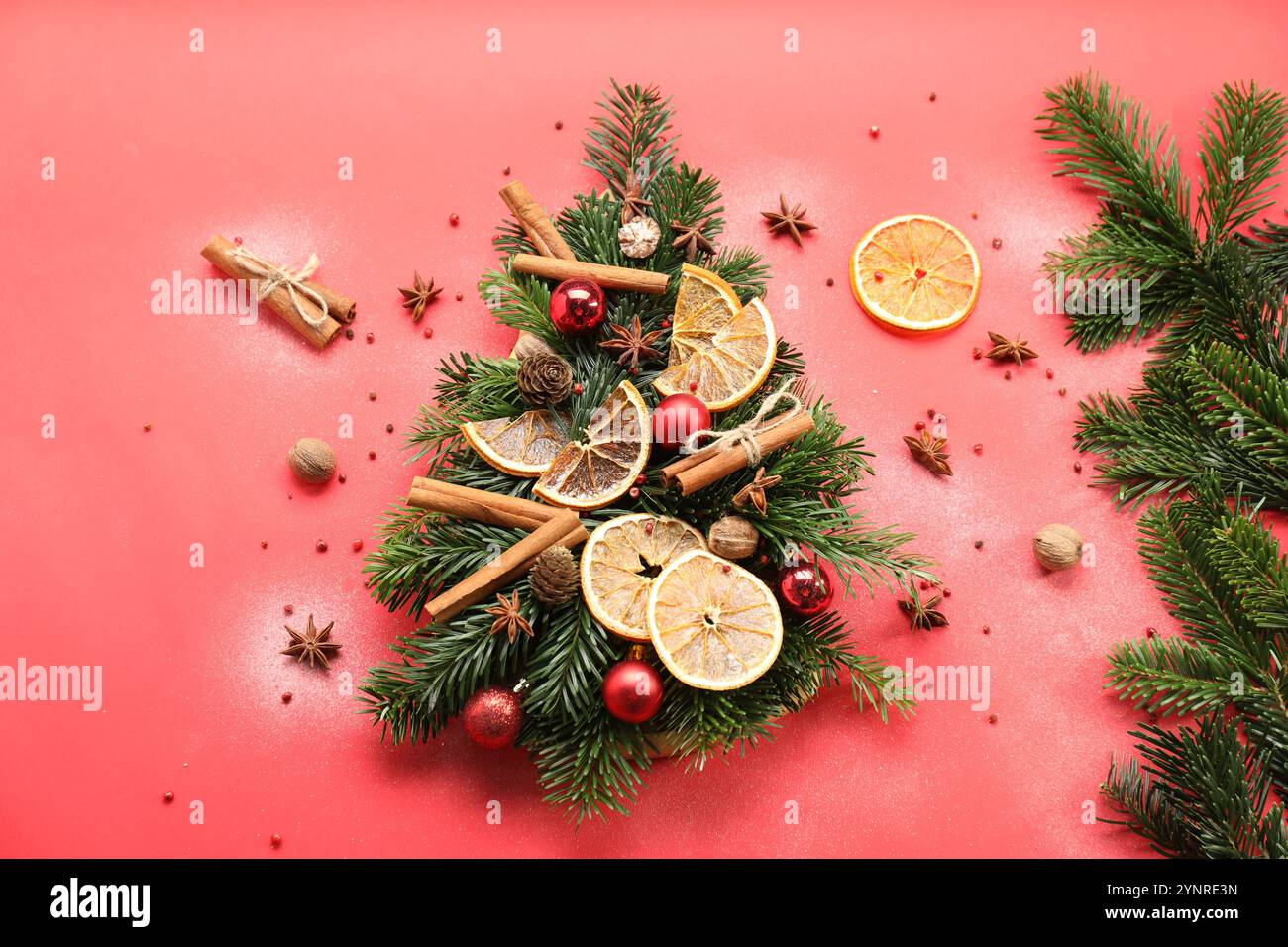 Christmas tree made of fir branches, baubles and different spices on ...
